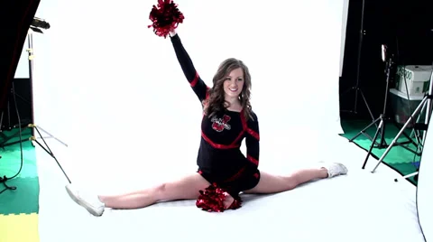 Cheerleader doing splits for photo shoot | Stock Video | Pond5