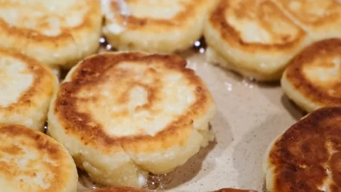 Cheesecakes are flying on a pan close-up... | Stock Video | Pond5