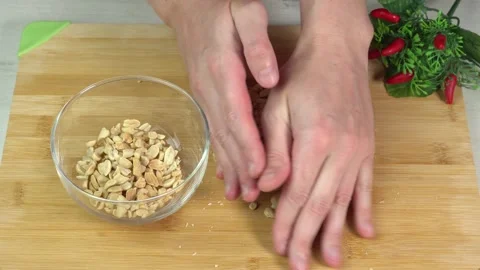 Chef pours roasted sliced peanuts with h... | Stock Video | Pond5