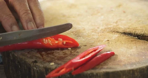 Chef slices the red chilli pepper. Cutti... | Stock Video | Pond5