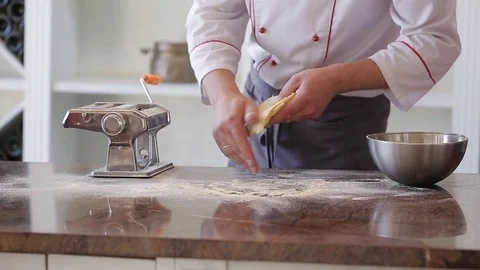Chef's hands use a pasta cutting machine... | Stock Video | Pond5