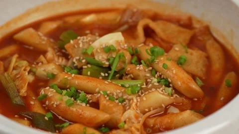 Chewy rice cakes simmered in a spicy, sa... | Stock Video | Pond5