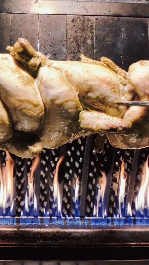 Chickens are roasting on a fire , tasty ... | Stock Video | Pond5