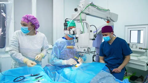 Chief surgeon using syringe during eye o... | Stock Video | Pond5