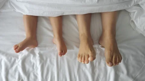 Child and mother wiggle toes sticking ou... | Stock Video | Pond5