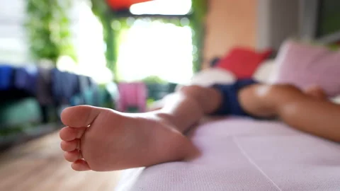 Child asleep on couch closeup feet toes ... | Stock Video | Pond5