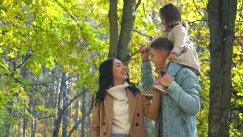 Child on the back of father. Happy famil... | Stock Video | Pond5