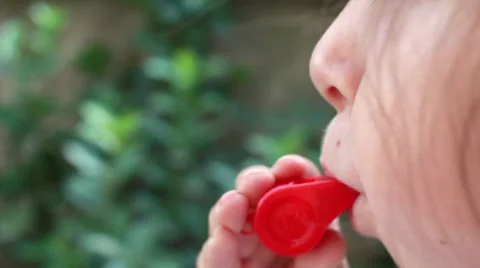 Child Blowing Whistle | Stock Video | Pond5