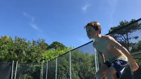 Child boy jumping inside swimming pool g... | Stock Video | Pond5