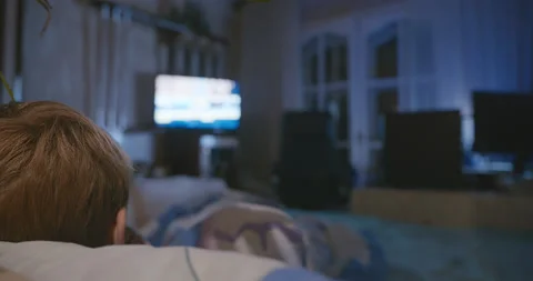 Child Boy Watch TV Set Lying on Bed. Lon... | Stock Video | Pond5