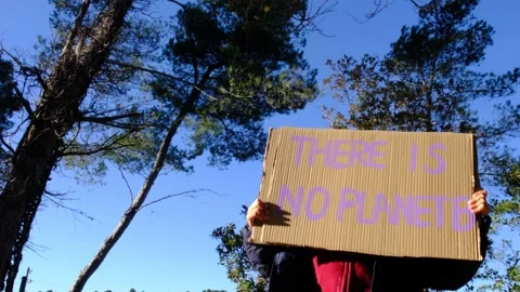 Child With a cardboard sign claiming the... | Stock Video | Pond5