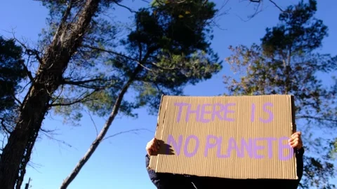 Child With a cardboard sign claiming the... | Stock Video | Pond5