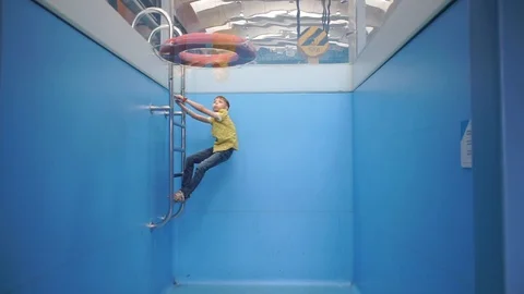 child in clothes in a dry pool | Stock Video | Pond5