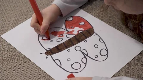 Child coloring a drawing with red. drawi... | Stock Video | Pond5