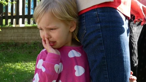 The child is crying, hiding behind his m... | Stock Video | Pond5