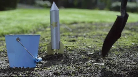 Child digging with bucket and rocket shi... | Stock Video | Pond5