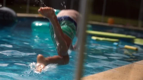 Child diving into swimming pool water. K... | Stock Video | Pond5