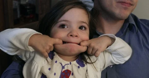 Child doing funny face with mouth | Stock Video | Pond5