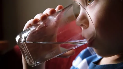 The child is drinking water from glass b... | Stock Video | Pond5