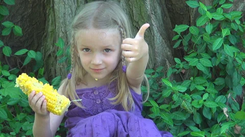 Child Eat a Boiled Corn in Park, Little ... | Stock Video | Pond5