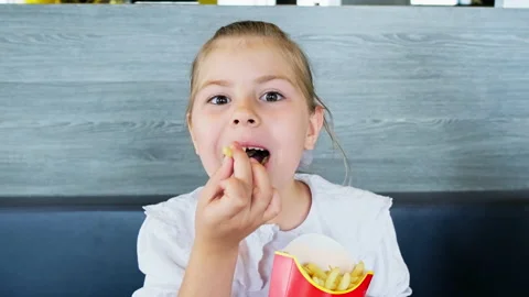 Child eating french fries in cafe. Littl... | Stock Video | Pond5
