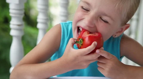 Child eating tomato. Close-up portrait. ... | Stock Video | Pond5