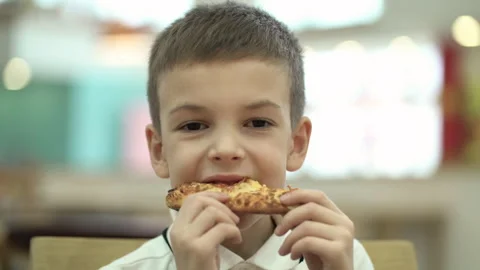 Child eats unhealthy food. Boy eats in a... | Stock Video | Pond5