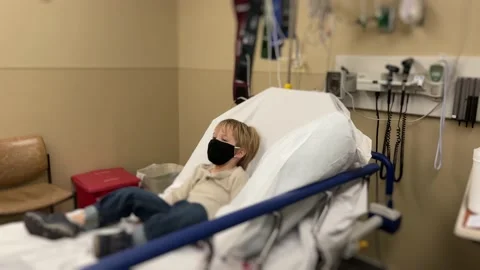 Child in Emergency Room Hospital Bed Dur... | Stock Video | Pond5