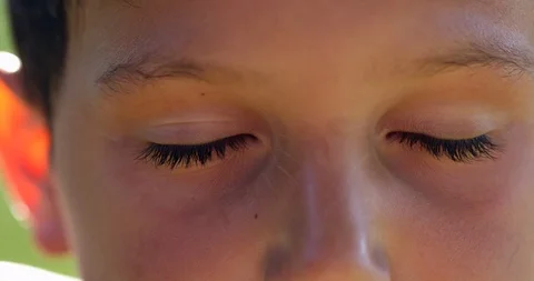 Child with eyes closed closeup. Kid open... | Stock Video | Pond5