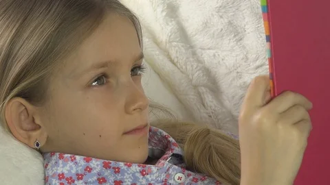 Child Face Reading Book on Sofa, Girl, K... | Stock Video | Pond5