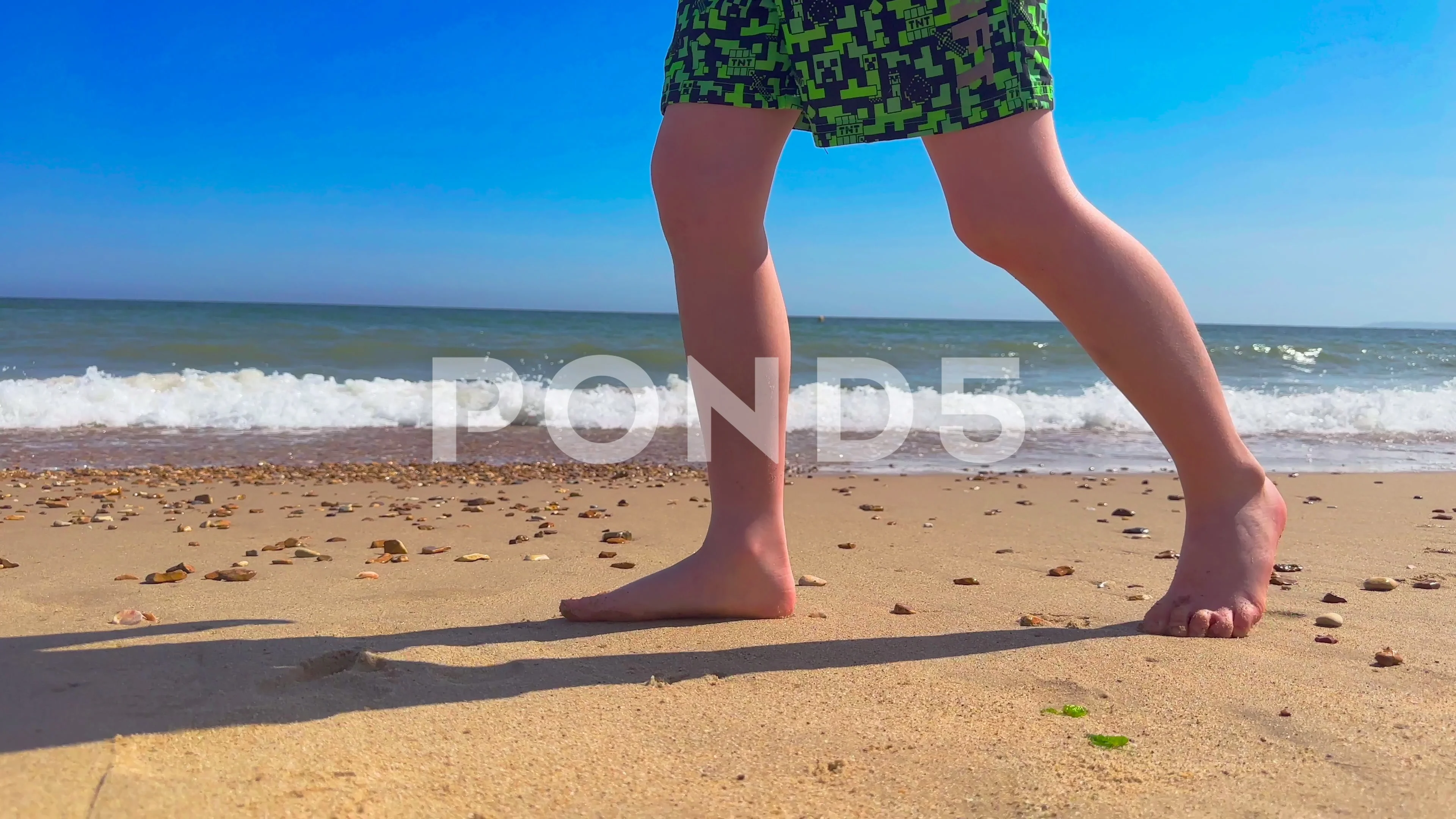 Legs Walking On The Beach