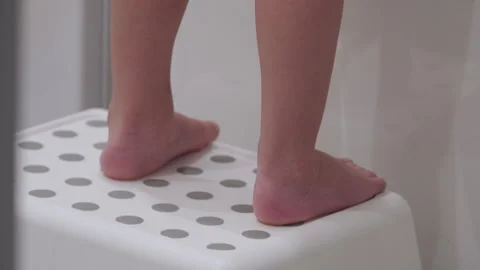 child feet on a stool in the bathroom, l... | Stock Video | Pond5
