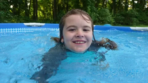 A child floating on a pool float in the ... | Stock Video | Pond5