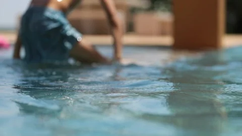 Child gets out of the swimming pool wate... | Stock Video | Pond5
