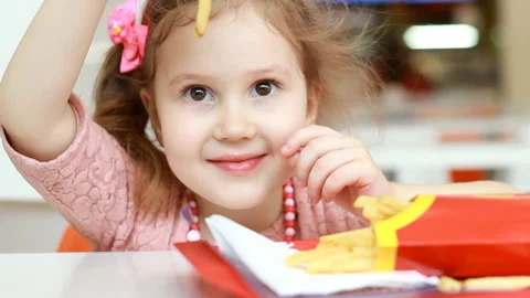 Child girl eating fast food french fries... | Stock Video | Pond5