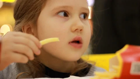 Child girl eating fast food french fries... | Stock Video | Pond5