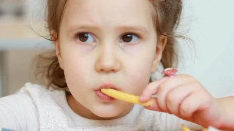Child girl eating french fries in the fa... | Stock Video | Pond5