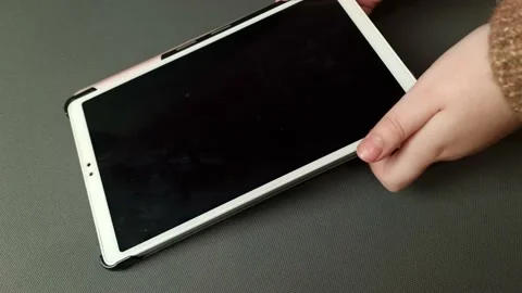 Child hands taking tablet computer lying... | Stock Video | Pond5