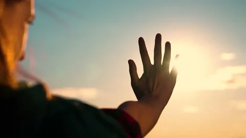 Child holds out his hand at sunset. Hand... | Stock Video | Pond5