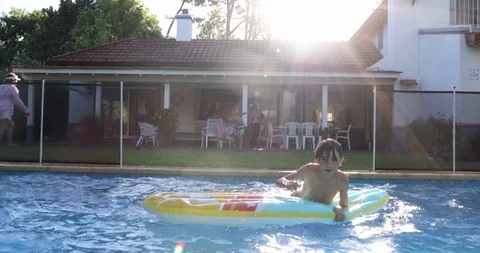 Child jumping inside swimming pool, spla... | Stock Video | Pond5