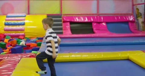 Child Jumping on Trampoline in Play Cent... | Stock Video | Pond5