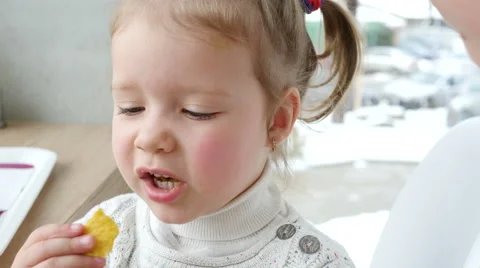 Child kid with mom eating potato snacks ... | Stock Video | Pond5
