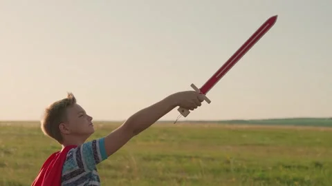 Child, kid with sword in hands playing s... | Stock Video | Pond5