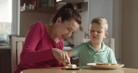 Child is Learning how to Spread a Butter... | Stock Video | Pond5