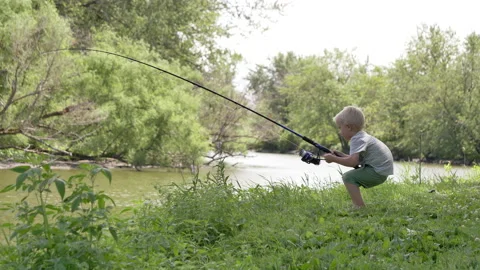Child (little boy) catching fish, holdi... | Stock Video | Pond5
