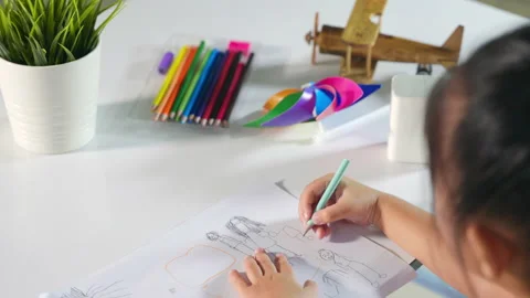 Child little girl drawing cartoon on pap... | Stock Video | Pond5
