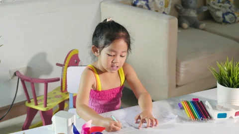 Child little girl drawing cartoon on pap... | Stock Video | Pond5