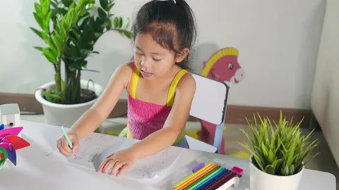 Child little girl drawing cartoon on pap... | Stock Video | Pond5