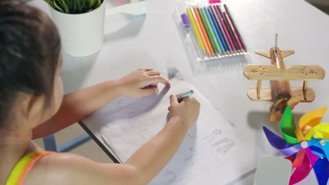 Child little girl drawing cartoon on pap... | Stock Video | Pond5