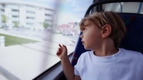 Child looking through bus window pointin... | Stock Video | Pond5